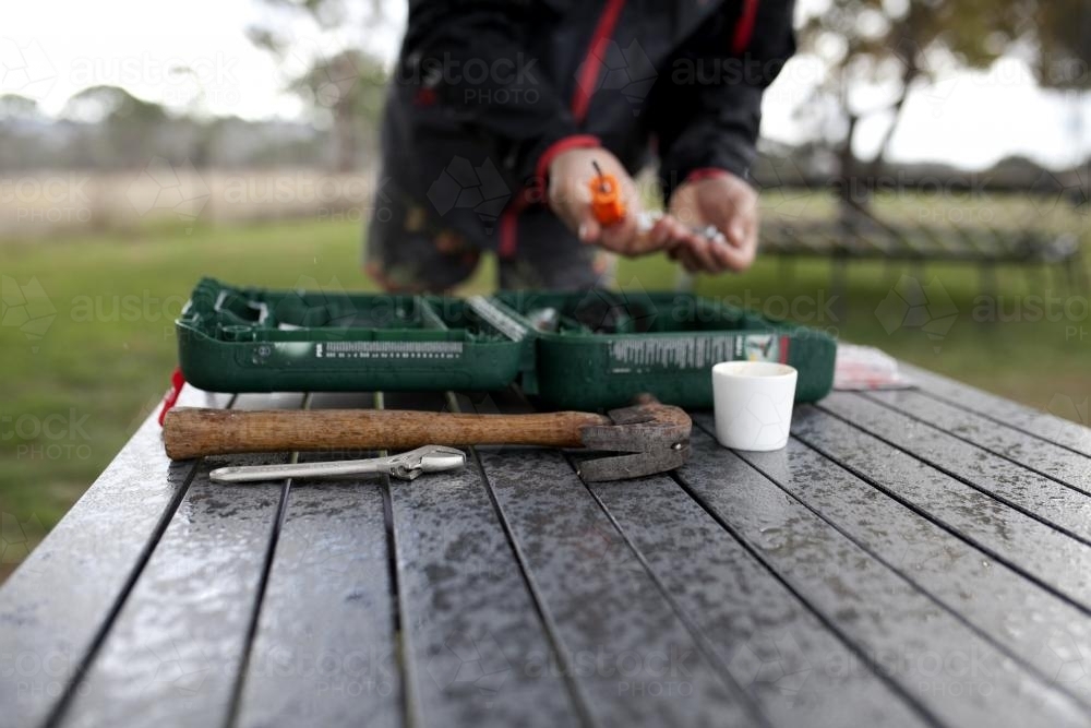 Image of Man with toolkit and tools in foreground - Austockphoto