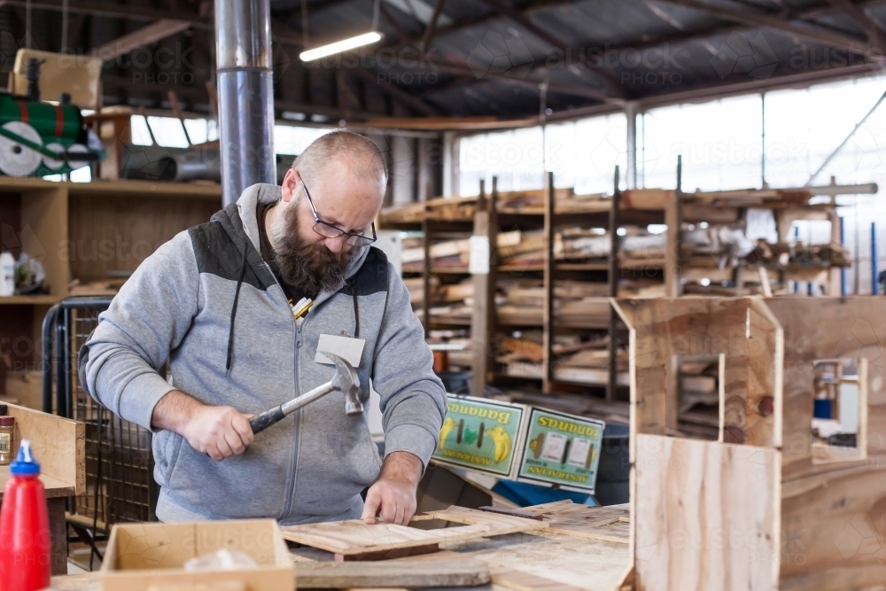 Image of Man working on a project at a men's shed - Austockphoto