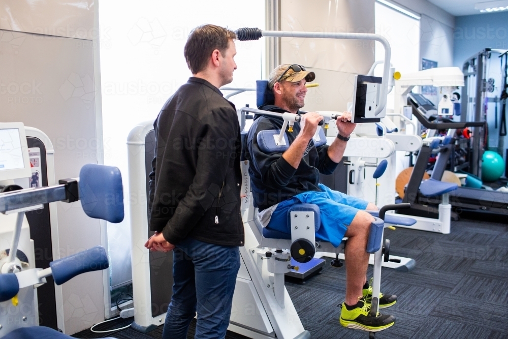 Image of Man working on exercise therapy equipment at physiotherapist ...