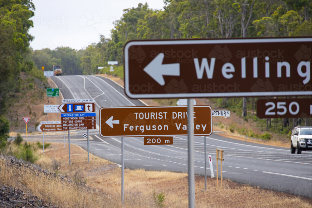 Image of many roadside road signs at intersection on highway between ...