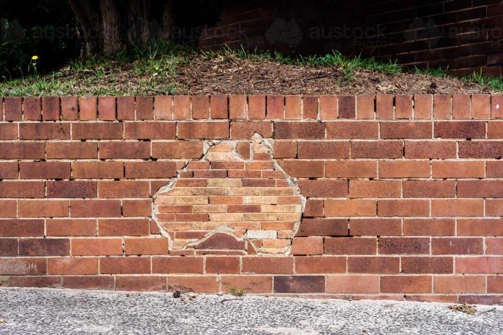 Image of map of australia in brick wall, minus tasmania - Austockphoto