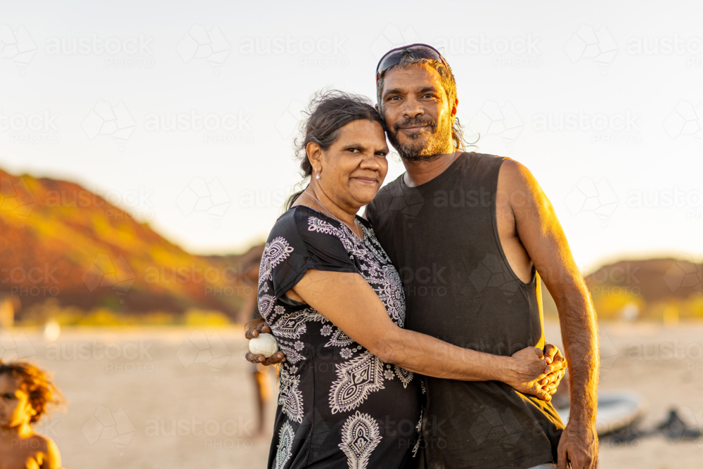 Image of mature aboriginal couple embracing outdoors in late afternoon ...
