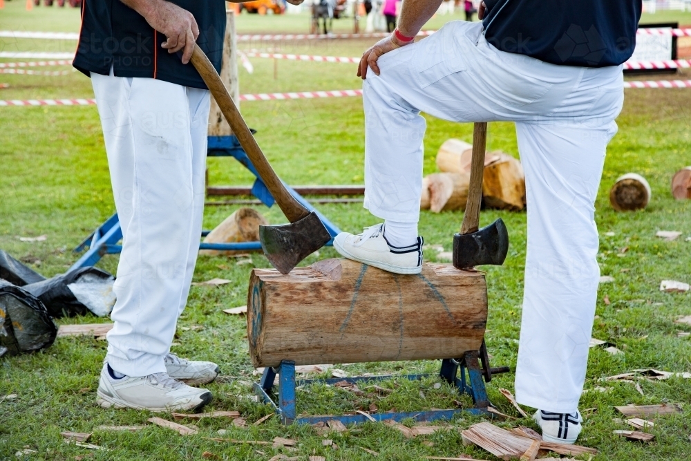 Image of Men resting axe on block for wood splitting competition ...
