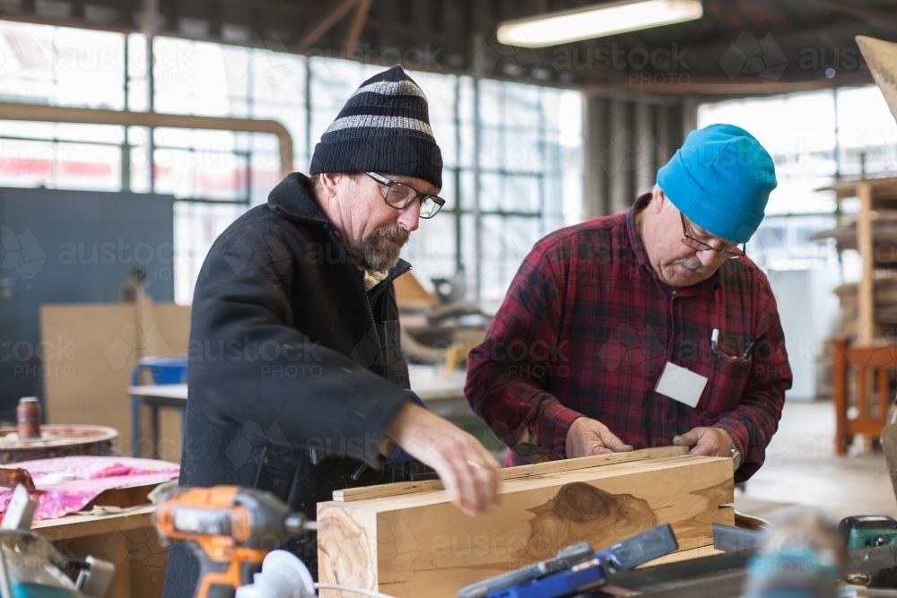 Image of Men working on a project at a Men's Shed - Austockphoto