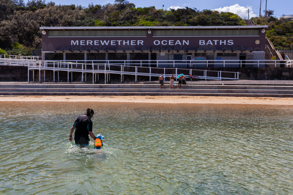 Image of Merewether ocean baths with adult and child wading towards the ...