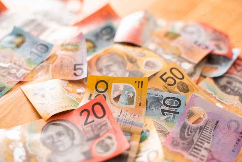 Image of messy heap of Australian dollars in different notes - Austockphoto