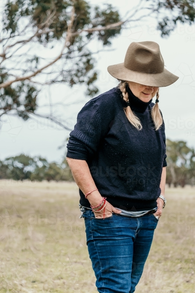 Image of Mid fifties woman in a hat on a farm. - Austockphoto