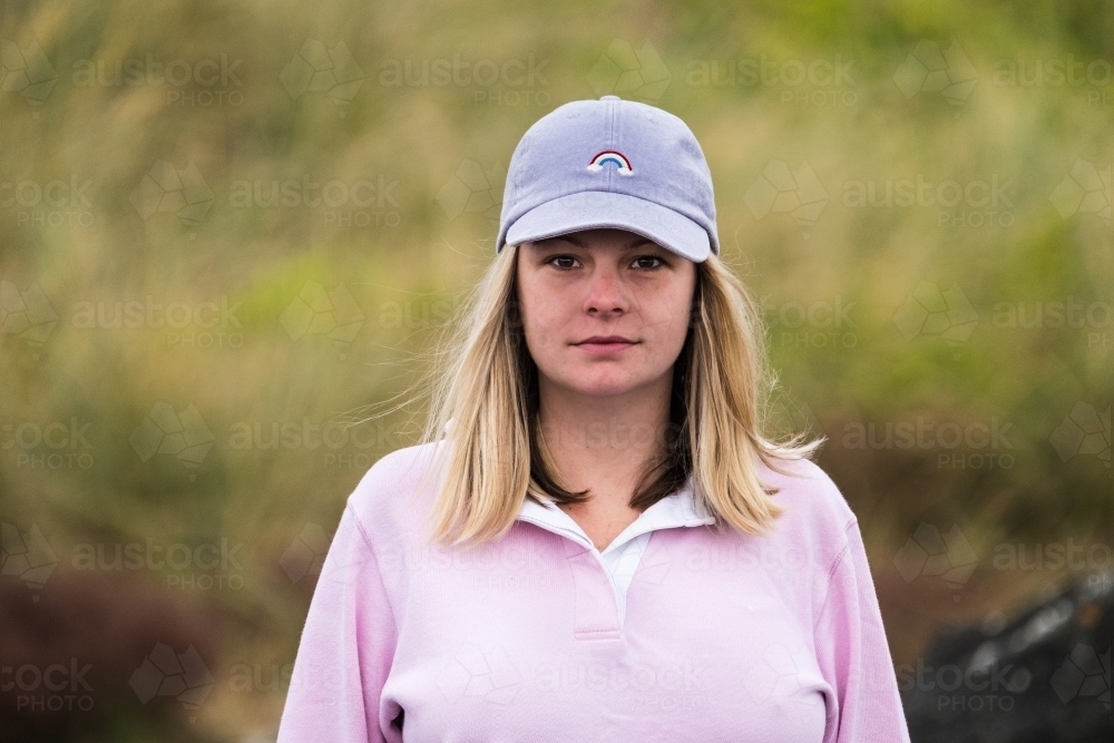 Image of Mid twenties girl looks at camera in casual clothes - Austockphoto