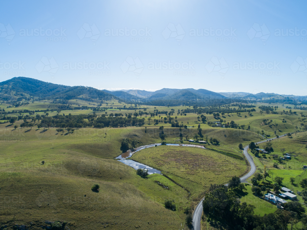 Image of midday aerial landscape view of green country paddocks under ...