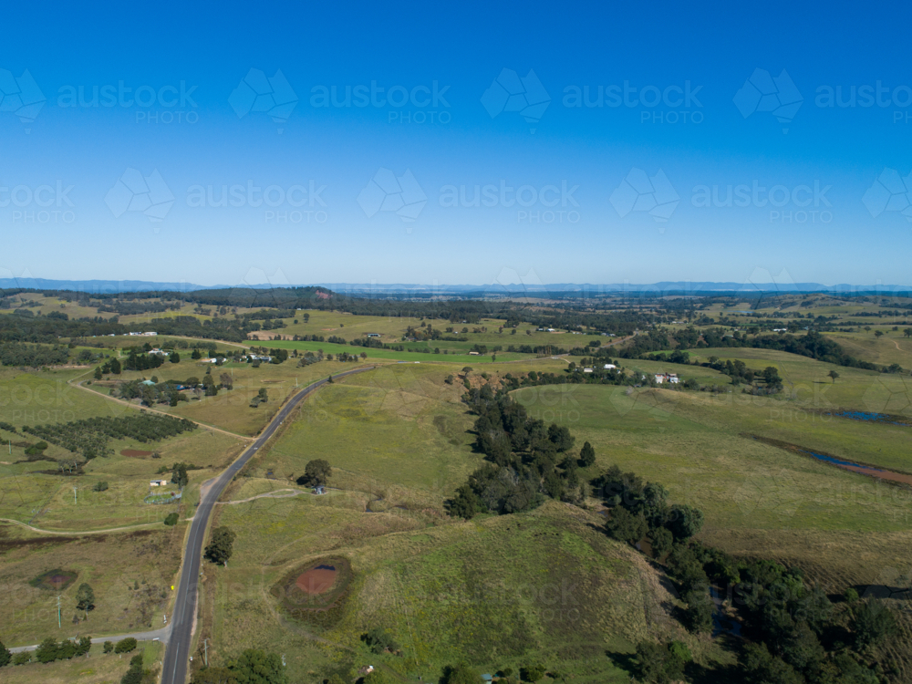 Image of midday aerial landscape view of green country paddocks under ...