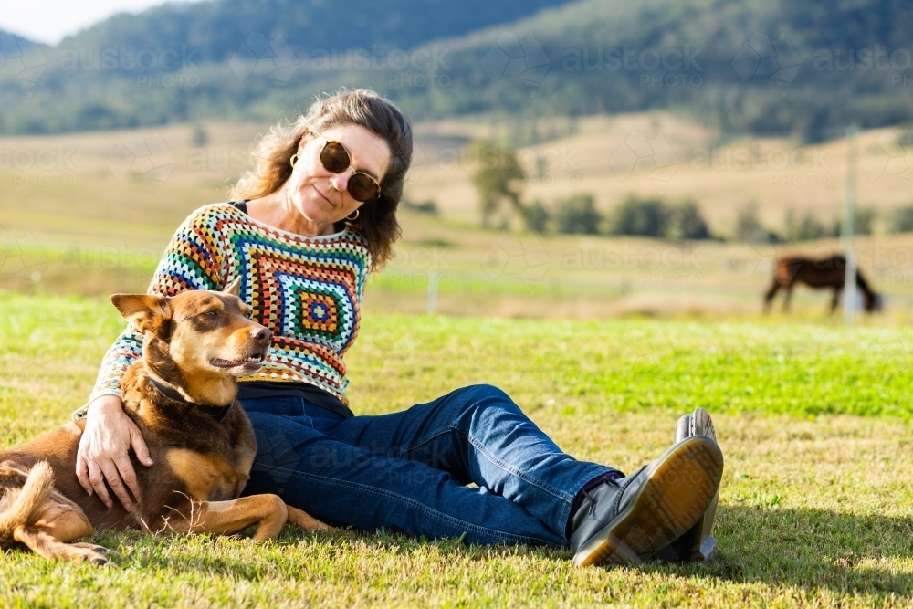 Image of middle age country woman relaxing on green lawn grass with her ...