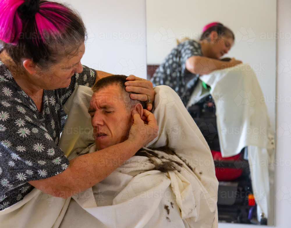 Image of Middle aged woman carer helping young man with disability ...