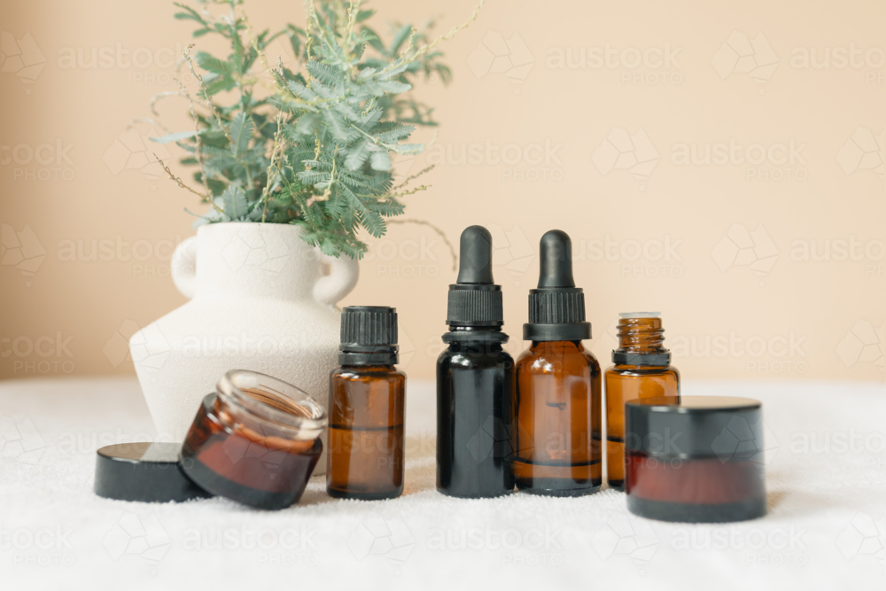 Image of Minimalist collection of amber essential oil products with ...