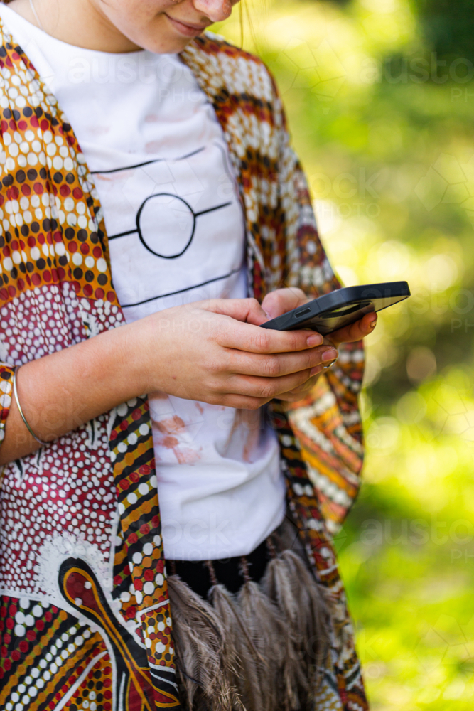 Image of Mobile phone device in hands of aboriginal teen girl ...