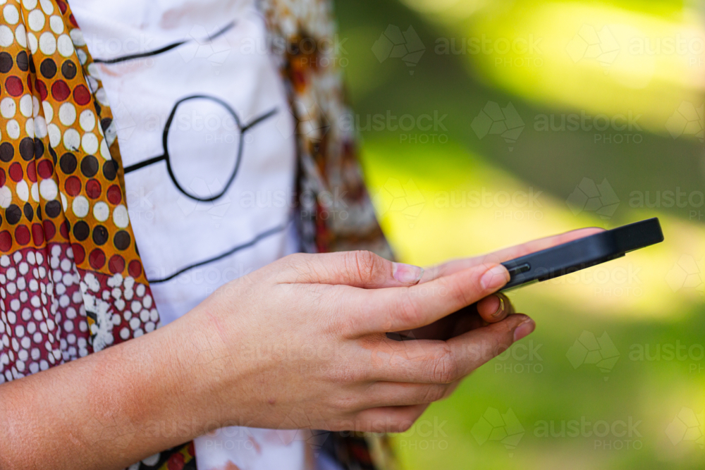 Image of Mobile phone device in hands of aboriginal teen girl ...