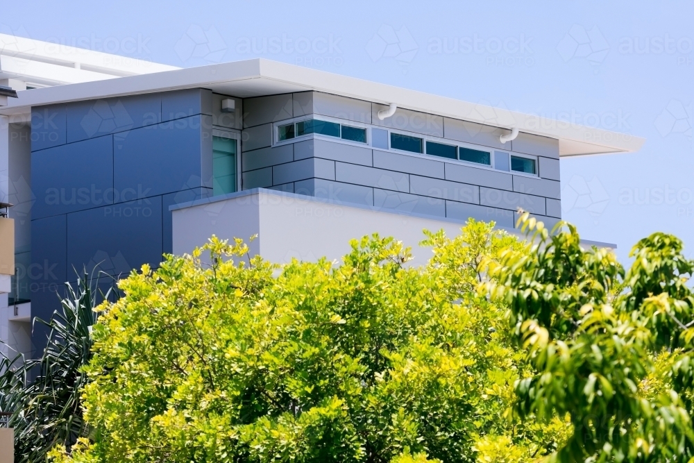 Image of Modern architectural building amongst trees - Austockphoto