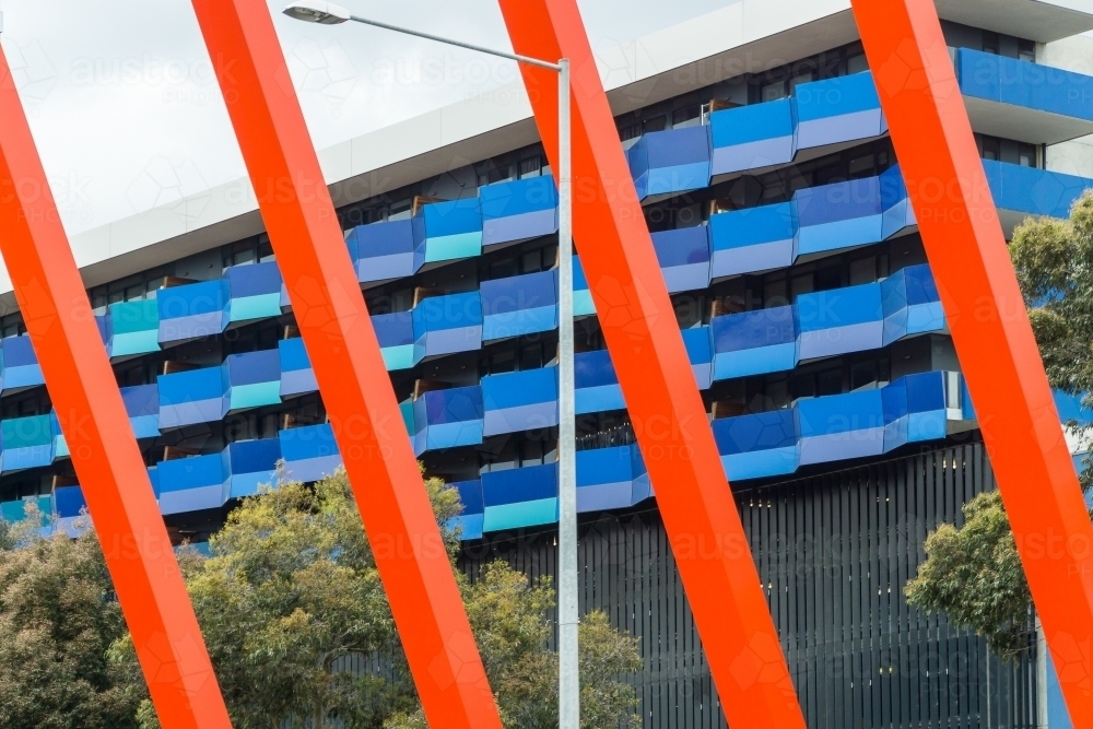Image of Modern, coloured columns in front a multi-story building ...