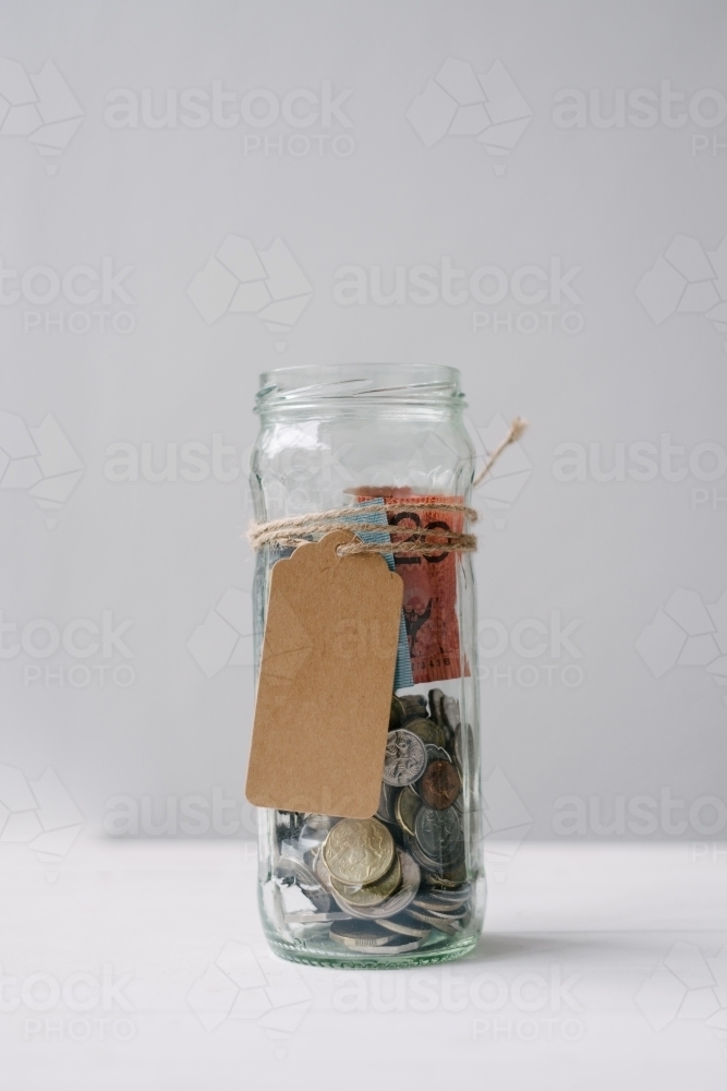 Image of Money jar with australian money and a blank tag - Austockphoto