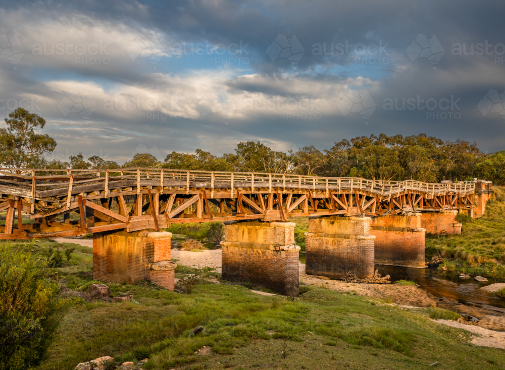 Image of Morning sun on an old rickety railway bridge underneath a ...