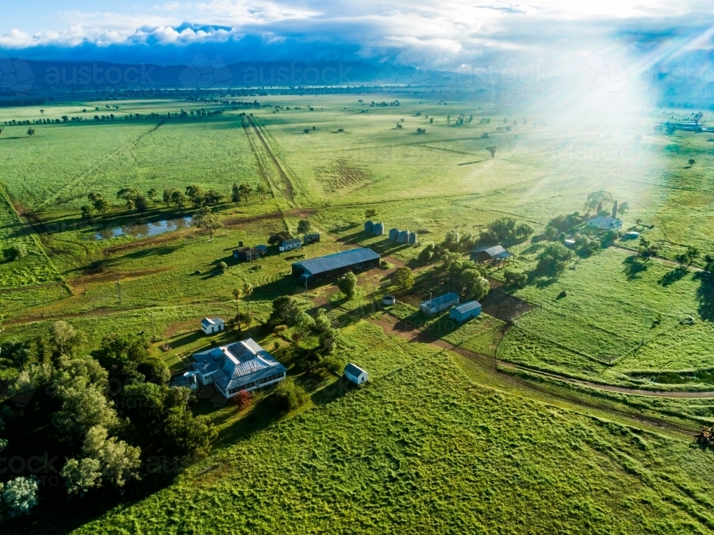 Image of Morning sunlight bursting over small country farmstead and ...