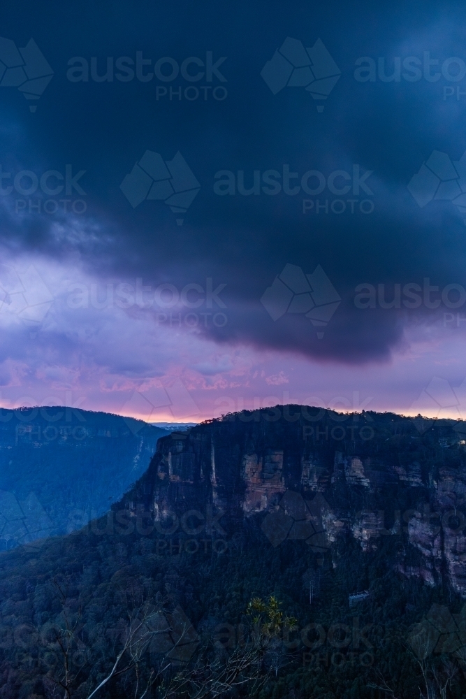Image of Mountain cliffs under pink and purple sunset sky with storm ...