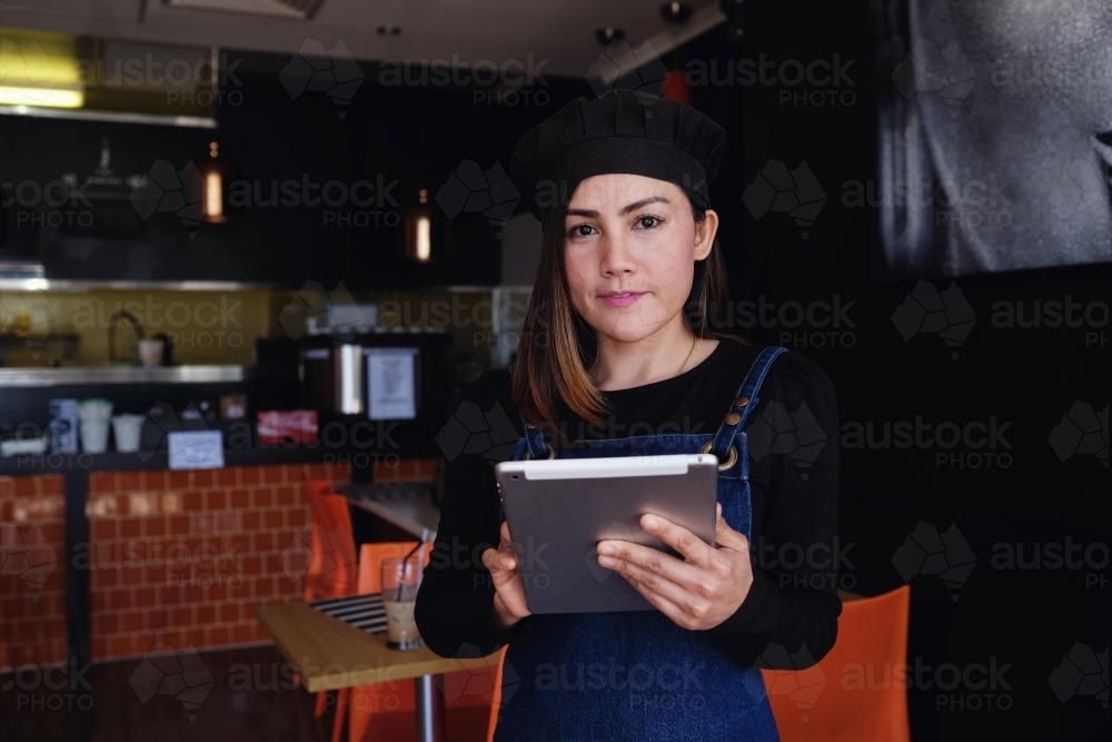 Image of Multicultural Asian waitress taking order at Thai restaurant ...