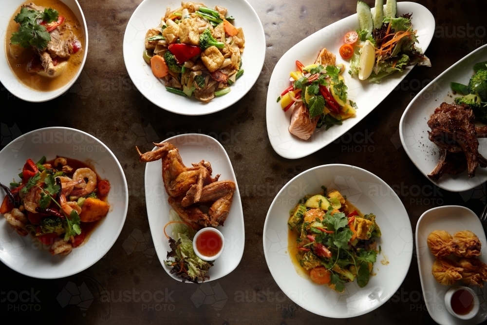Image of Multiple Thai food dishes on table - Austockphoto
