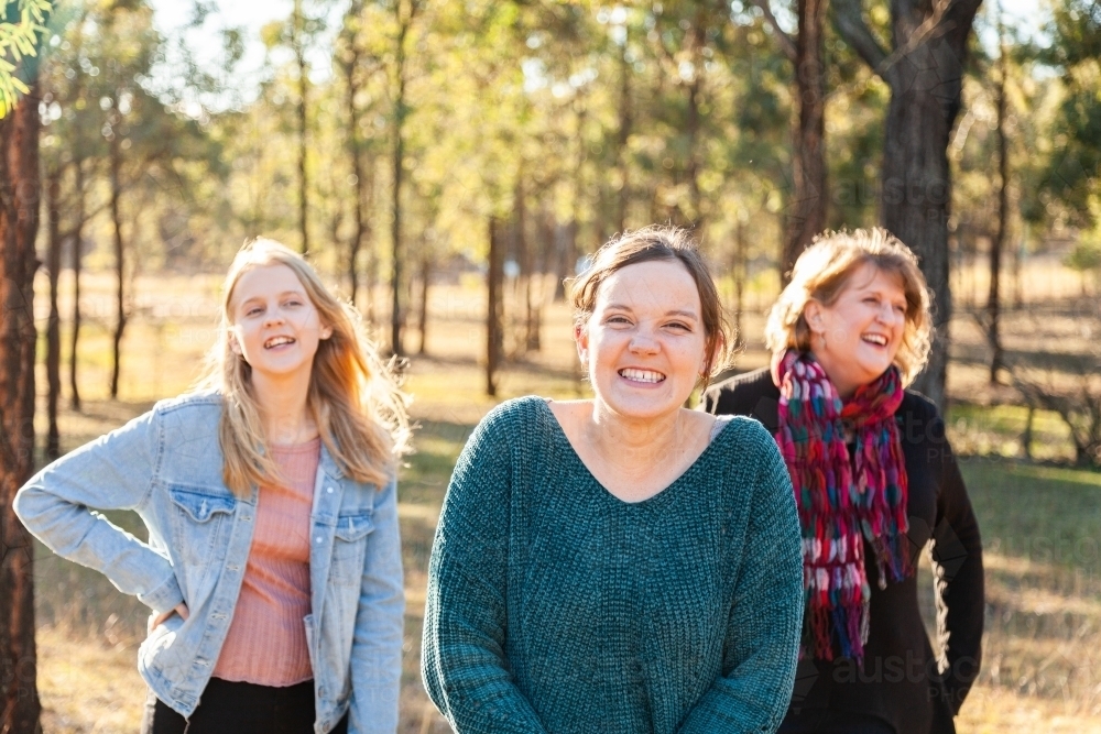 Image of Mum and daughters laughing together - Austockphoto