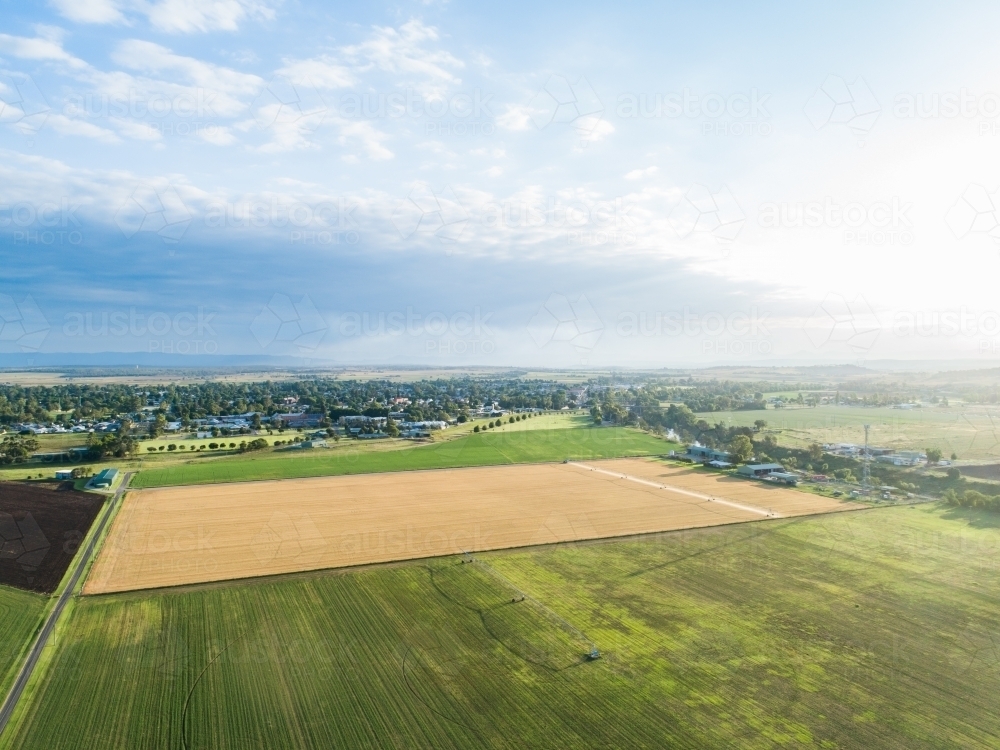 Image of narrow country road through sunlit rural farm paddocks in ...