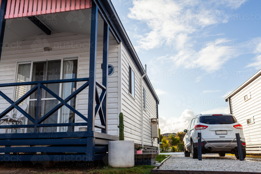 Image of Neat little holiday cabin with veranda porch - Austockphoto