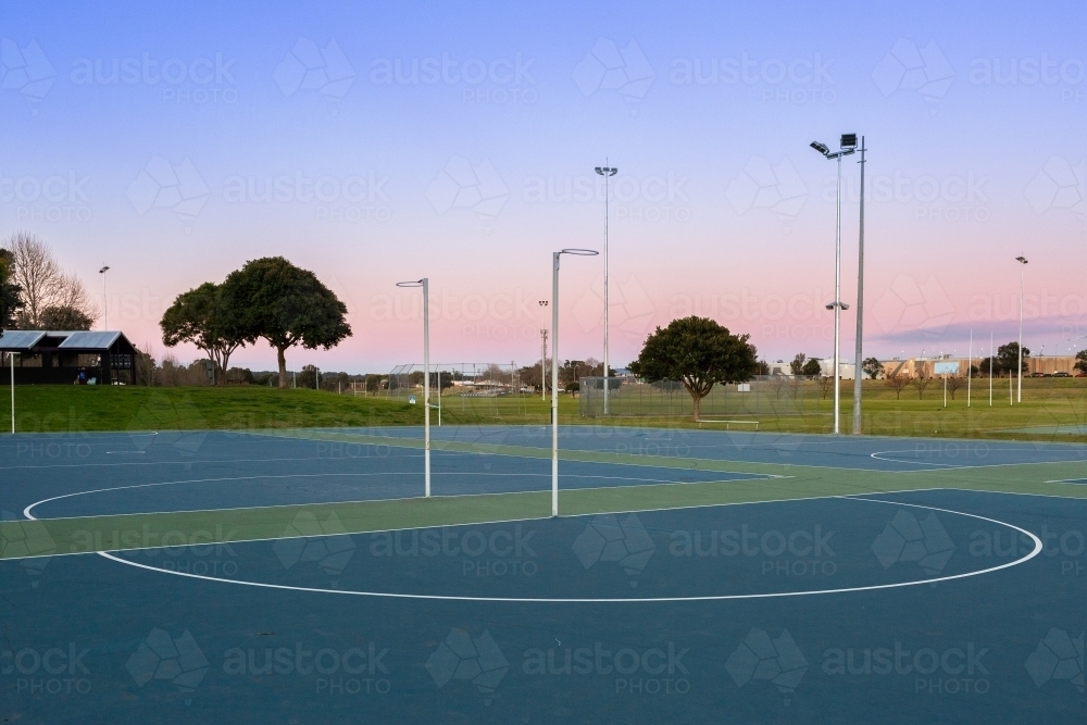 Image of Netball hoop at empty community sports ground in dusk light ...