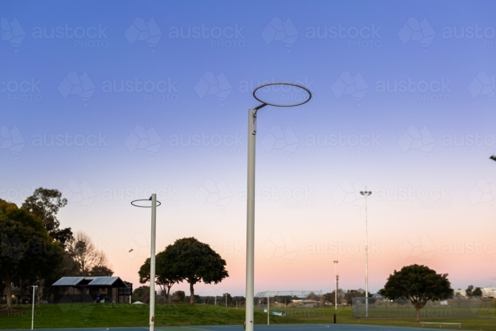 Image of Netball hoops at dusk - Austockphoto