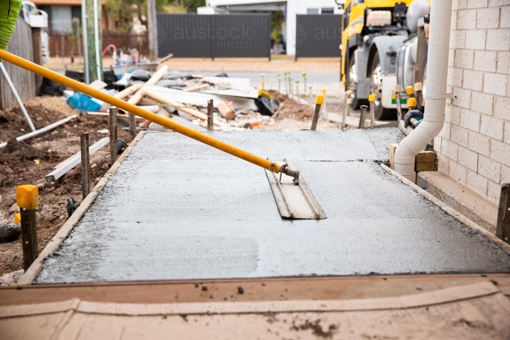 Image of new cement path being smoothed - Austockphoto