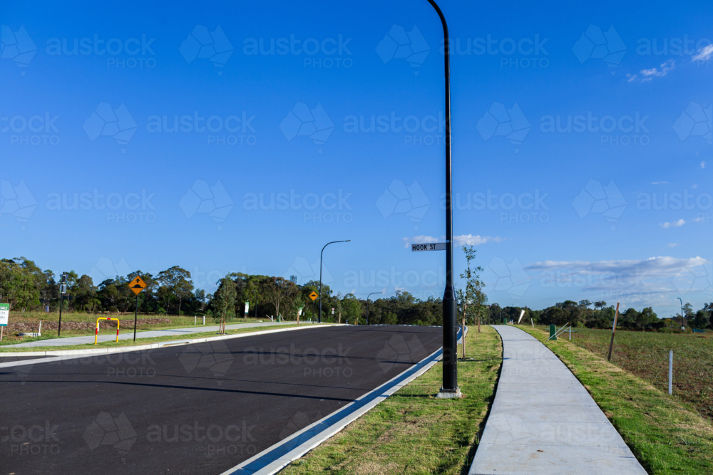 Image of New road infrastructure in housing suburb under construction ...