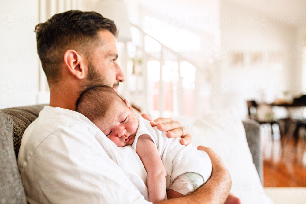 Image of Newborn baby boy sleeping on fathers chest - Austockphoto