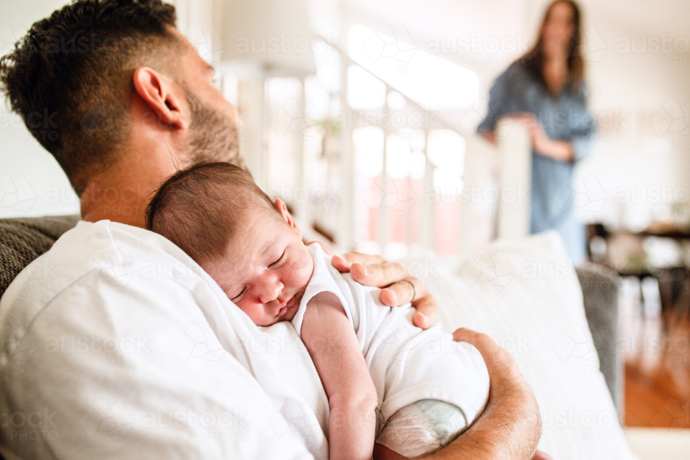 Image of Newborn baby boy sleeping on fathers chest - Austockphoto