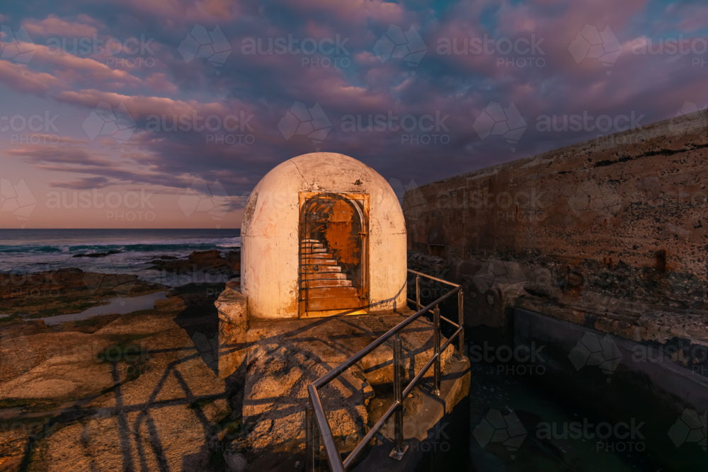Image of Newcastle Ocean Baths pump house at sunset - Austockphoto