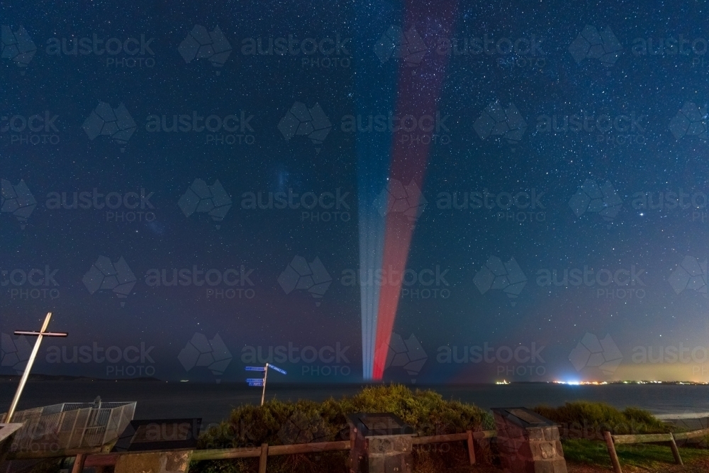 Image of Night time scene of laser lights against a starry sky above ...