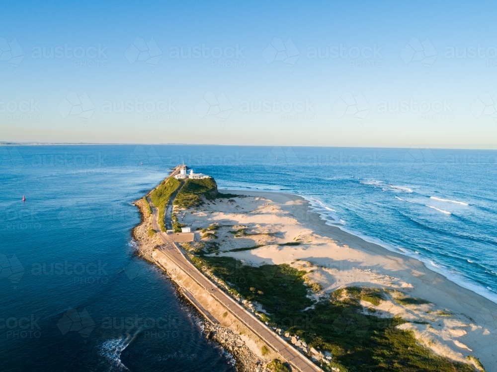 Image of Nobbys beach headland and lighthouse in last evening light ...