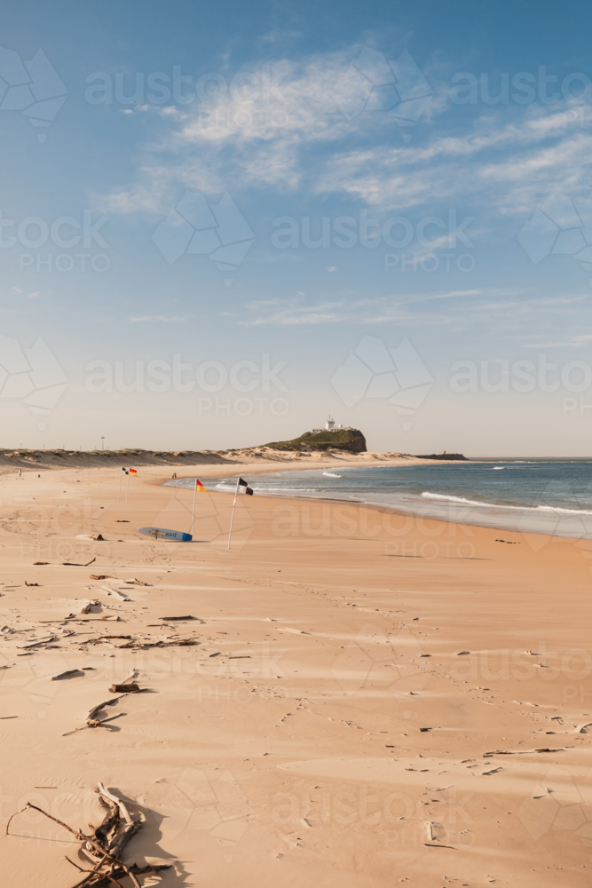 Image of Nobbys Beach in Newcastle with lifeguard flags and lighthouse ...