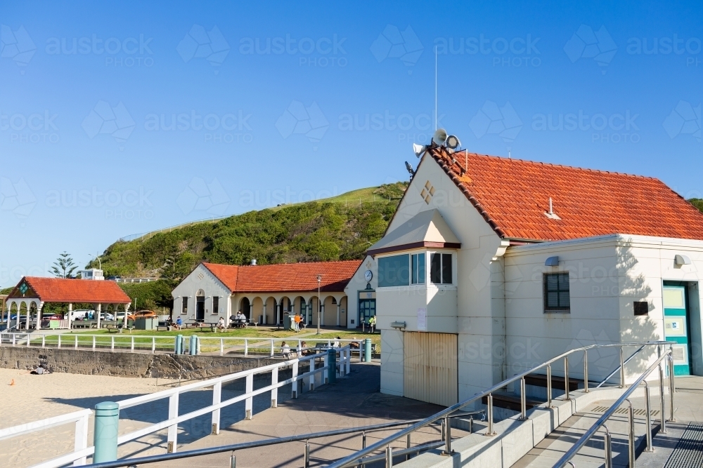 Image of Nobbys Beach surf pavilion beside the sea on sunlit winter day ...