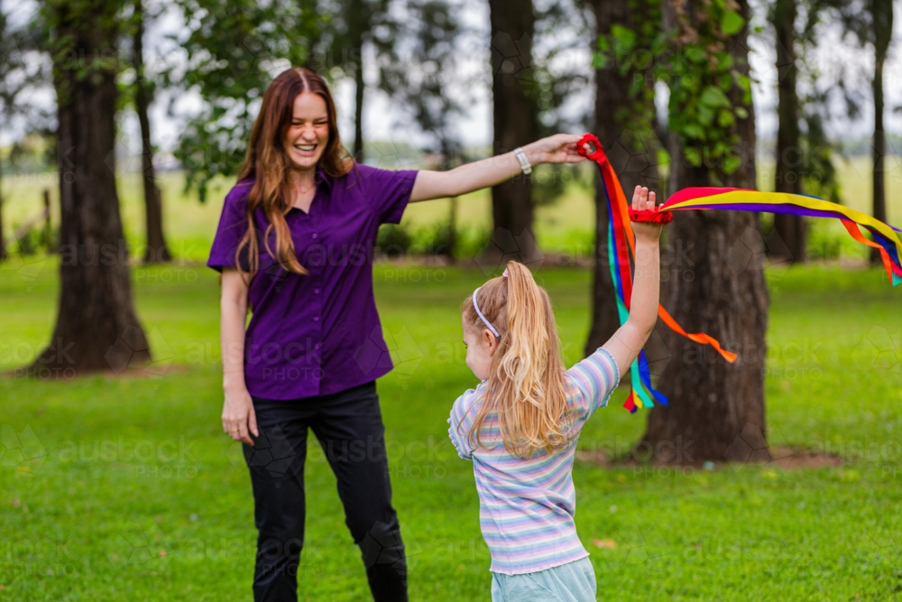 Image of Occupational therapist assessing girl with rainbow streamers ...