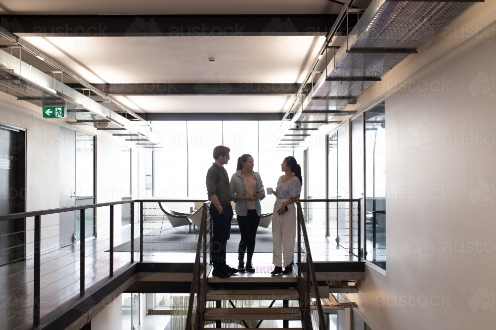 Image of Office workers standing on top of the stair in an industrial ...