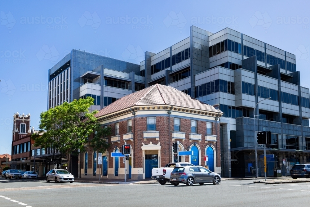 Image of Old and new bank buildings together at street corner in ...