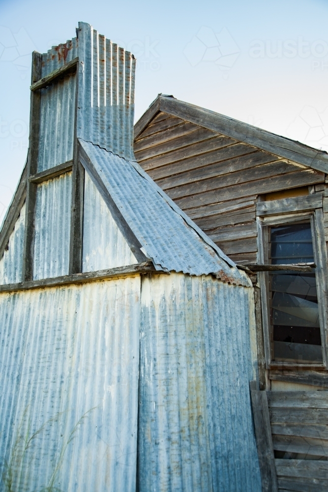 Image of Old tin chimney on a farm outbuilding - Austockphoto