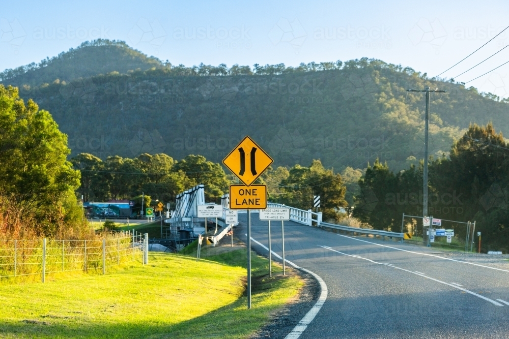 Image of One lane sign before old wooden bridge in Bulga in sunset ...