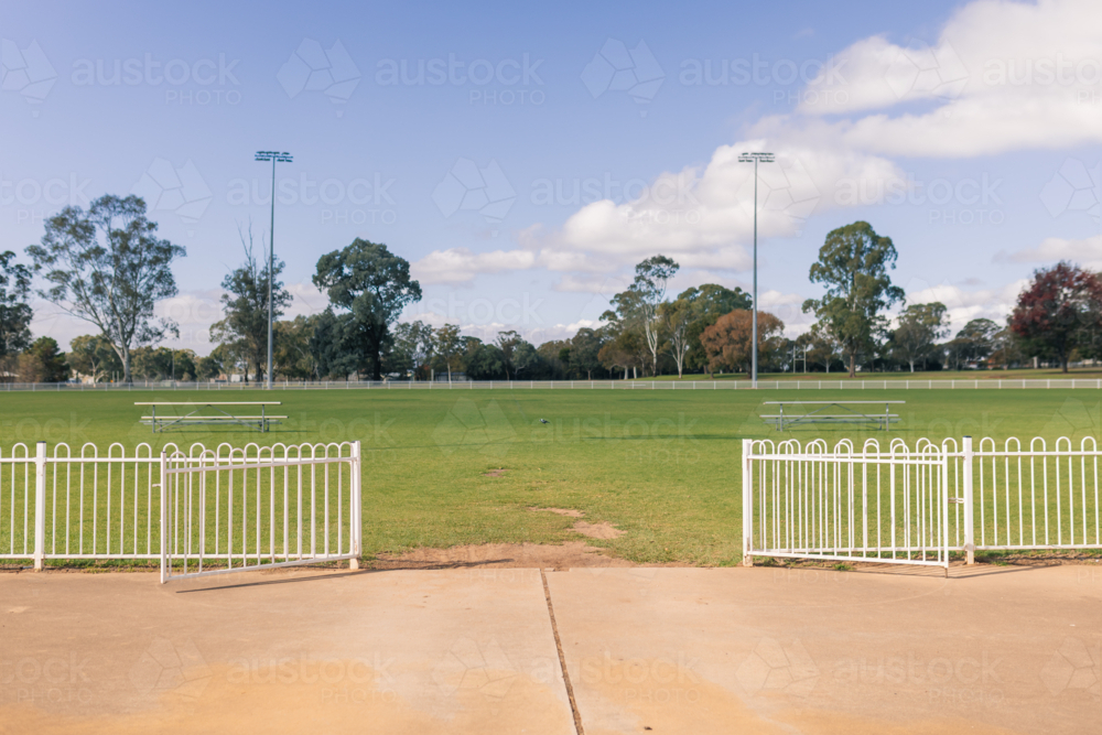 Image of Open gates leading onto football field with spectator seating ...