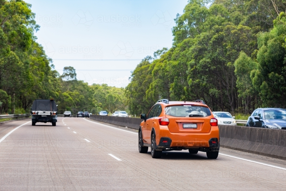 Image of orange car among traffic on highway in NSW australia ...