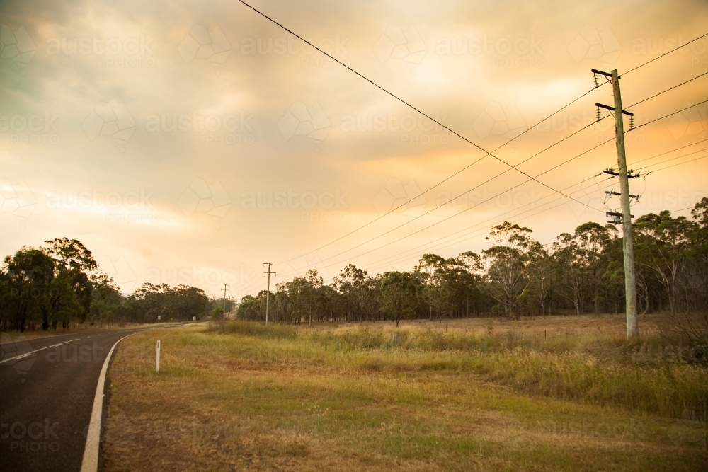 Image of Orange smokey sky from bushfire country road and powerlines ...