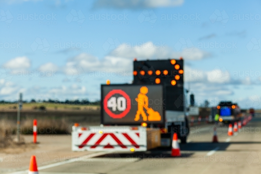 Image of Out of focus background of roadwork signs and 40 speed zone ...